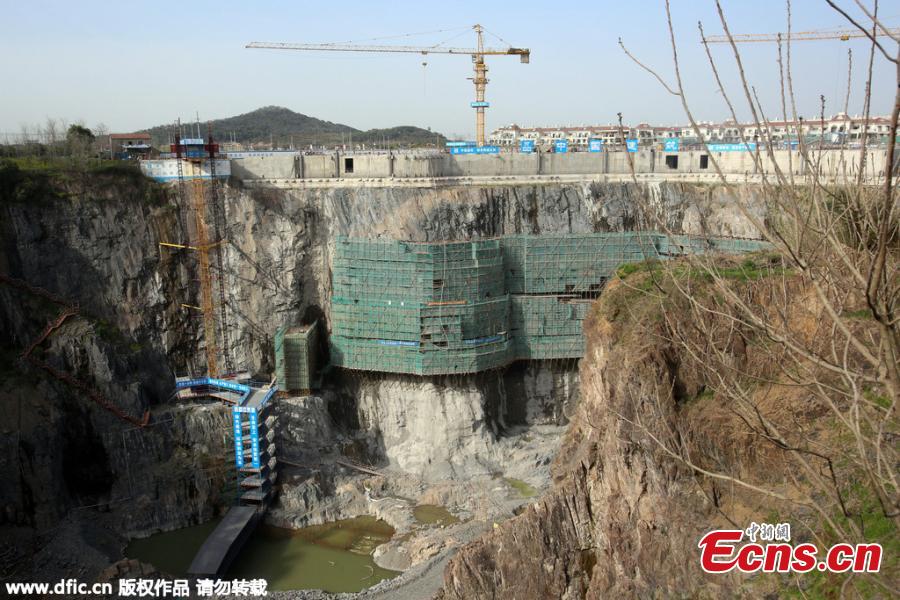 Green protective wall under construction for 'Deep Pit' hotel (2/3 ...